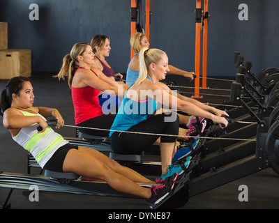 Women Using Rowing Machines In Gym Stock Photo - Alamy
