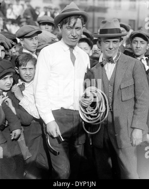Will Rogers (1879-1935), American cowboy humorist, film star, entertainer, and writer, holding ...