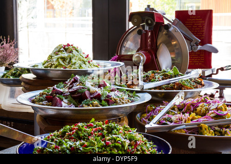 A selection of salads on display in a restaurant window with focus on ...
