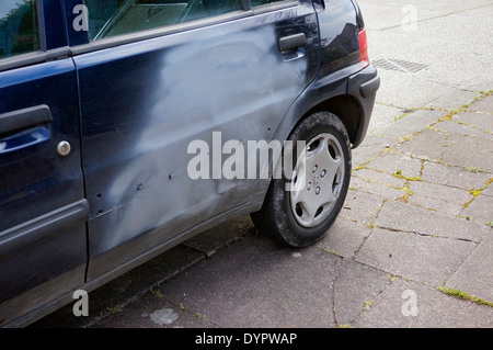 A car parked on a pavement, causing an obstruction for pedestrians ...