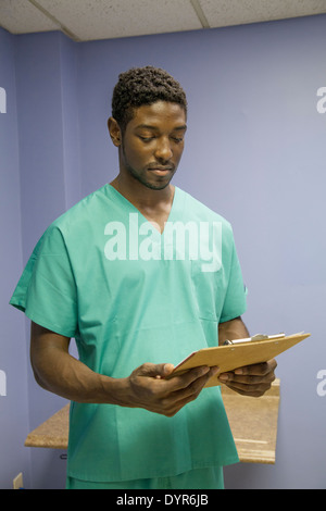 Doctor reading patient files Stock Photo - Alamy