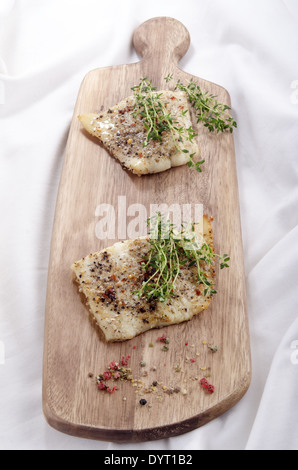 grilled cod with fresh thyme and pepper on a wooden board Stock Photo ...