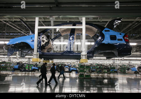 Workers assemble a vehicle on the production line of Kia Motors Corp ...