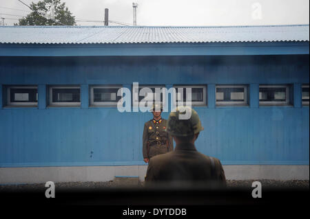 Guards from North and South Korea stand next to the light blue UN ...