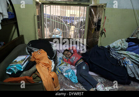 A Palestinian girl sits inside a house damaged during the Israel-Hamas ...
