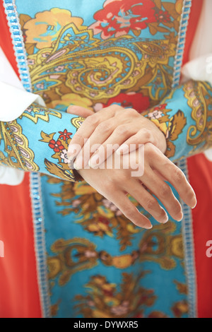 Cropped photo of hands of woman artist stained with red paint painting ...