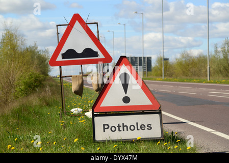 A pot hole warning sign Stock Photo - Alamy