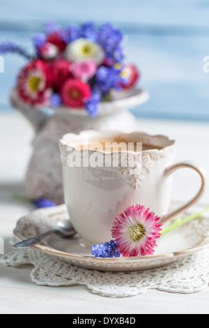 Hot Espresso coffee with blue spring flowers Stock Photo - Alamy