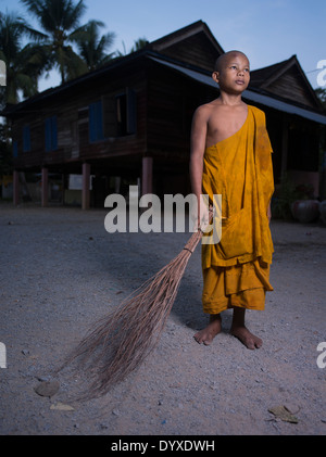 Buddhist monk sweeping temple grounds in the historic town of Galle ...