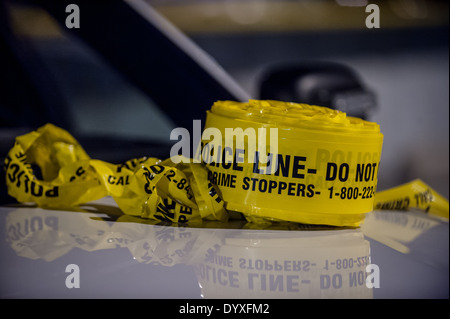 A roll of crime scene tape sits on the hood of a Toronto police car ...