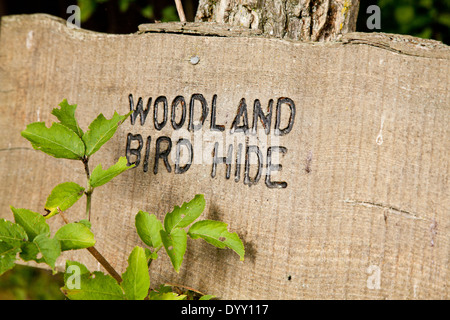 Nature trail with wildlife walk signpost in woodland scene at Bruern ...