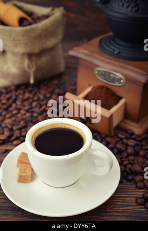 Coffee grinder and cup of coffee on burlap background Stock Photo - Alamy