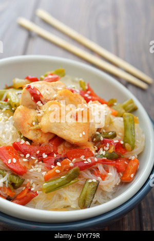 Tasty rice noodles in bowl and chopsticks on red table, closeup Stock ...