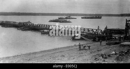 German soldiers cross a pontoon bridge from Branau, Austria to Simbach ...