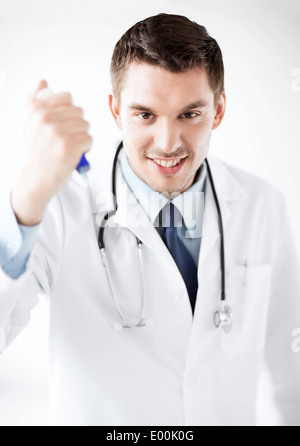 evil doctor holding syringe with injection Stock Photo - Alamy
