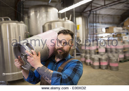 Man Carrying a Beer Keg on His Shoulder in a Brewery Stock Photo ...