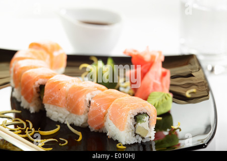 cold sushi on black dish and white background Stock Photo - Alamy