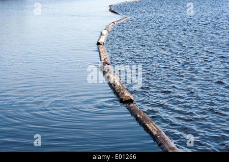 log boom barrier floating on water, Finland Stock Photo - Alamy
