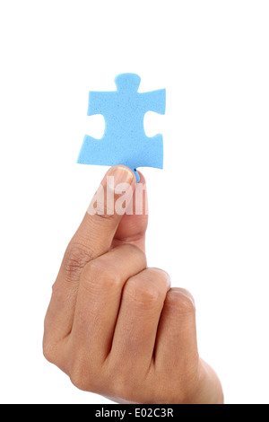 Hand with blue jigsaw puzzle isolated on white background Stock Photo ...