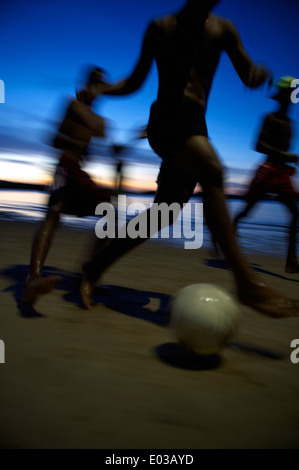 Beach soccer players chasing the ball Stock Photo - Alamy