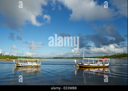 Brazilian boats reflecting in tranquil waters on a remote coast in ...