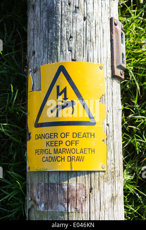 Notices on the side of a fallen pylon warns of the dangers of ...