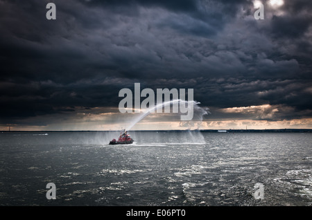 small fireboat demonstrating its capabilities on Baltic Sea in Gdansk ...