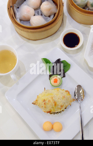 Crab meat stuffed crab shell and dim sum Chinese cuisine on a plate at ...