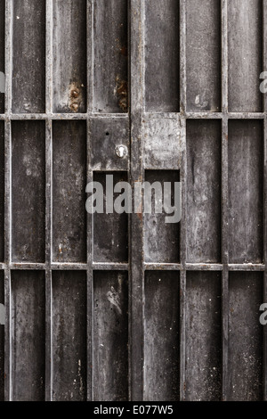 Iron door to the prison cell with a hole for food and window with bars ...