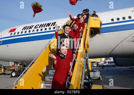 Air crew members pose for photos in front of Air China's first Boeing ...