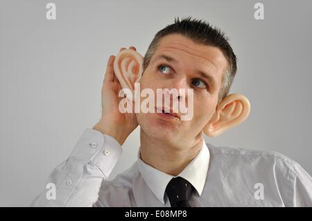 Illustration - A man wearing giant rubber ears spies on the surrounding ...