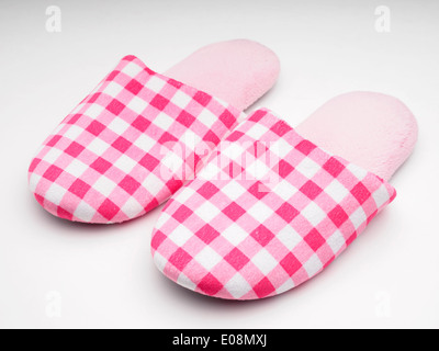 Pink warm women's slippers on a blue background Stock Photo - Alamy