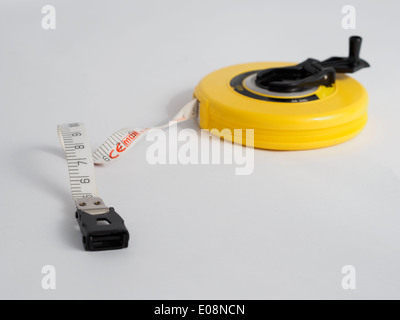 Measuring length with a tape measure on a table Stock Photo - Alamy