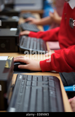 Primary school pupils using computers in classroom. Children in ...