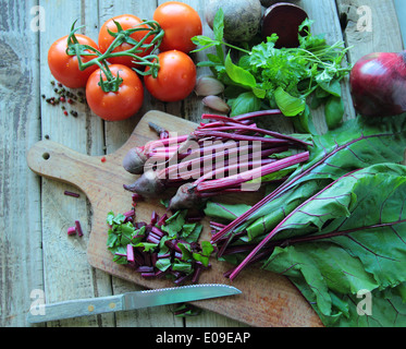 Vegetables for salad, knife and cutting board on the table. Preparation ...