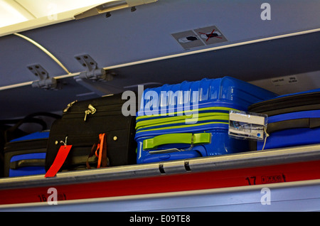 The luggage compartment in an airplane above passenger Stock Photo ...