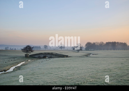 A view of the arched bridge over the beck that runs through Hovingham ...