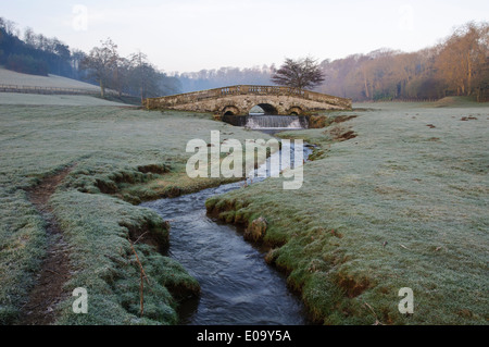 A view of the arched bridge over the beck that runs through Hovingham ...