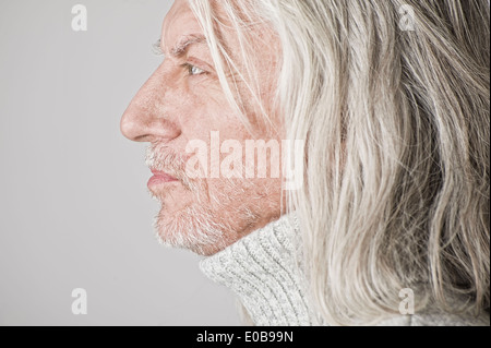 Profile portrait of a man with a long beard and a short haircut in ...