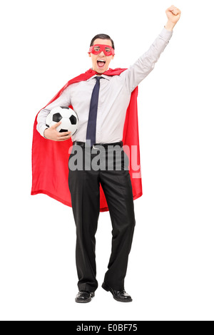 Superhero cheering and holding a football isolated on white background ...