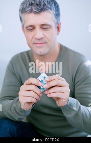 Man taking medication Stock Photo - Alamy