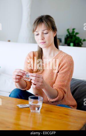 Woman taking tablets Stock Photo - Alamy