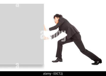 Young businessman pushing a blank board on white background Stock Photo ...