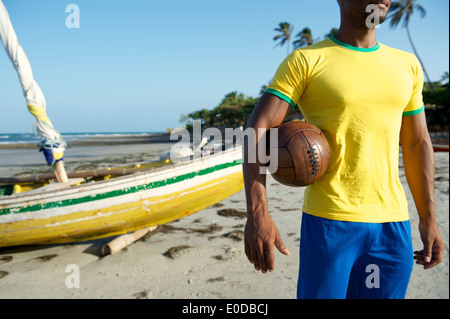 Brazilian football player in Brazil colors holding soccer ball in front ...