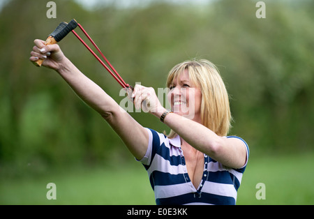 Woman firing a catapult in the countryside England UK Stock Photo - Alamy