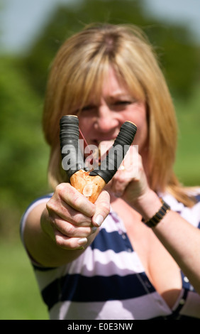 Woman firing a catapult in the countryside England UK Stock Photo - Alamy