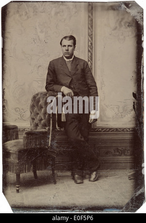 This historic portrait, taken between 1900 and 1920, depicts three ...