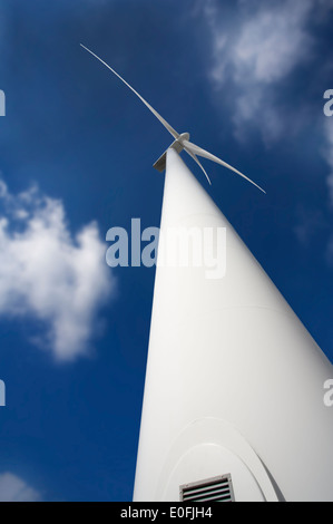 Low angle shot of a wind turbine on top of a hill captured on a cloudy ...