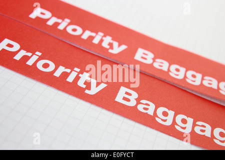 Red label priority for baggage Stock Photo - Alamy