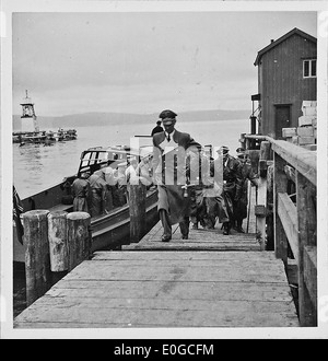 A photograph of a harbor tour in Trondheim during World War II, showing ...